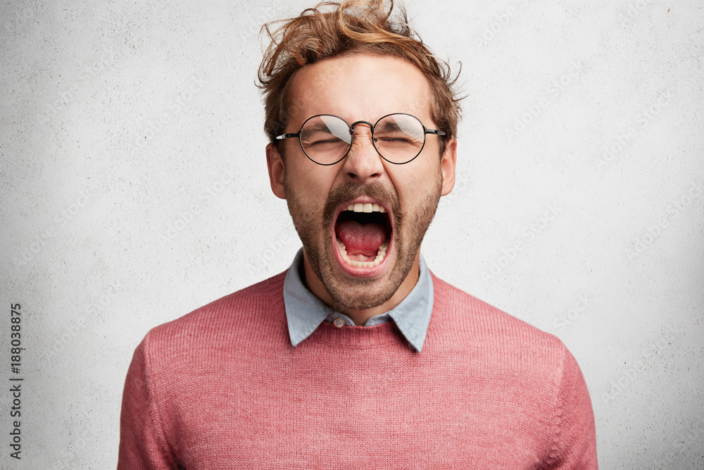 Emotional mad crazy young male screams loudly and with anger, being ...