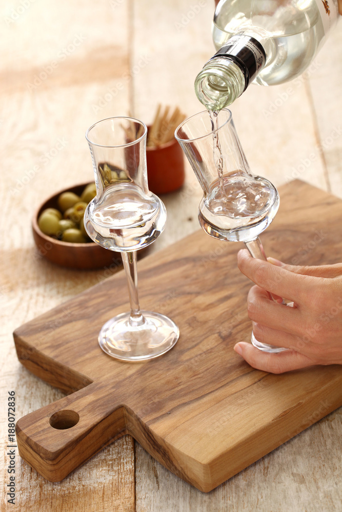 two glasses of Grappa bianca, italian digestif, grape-based pomace ...