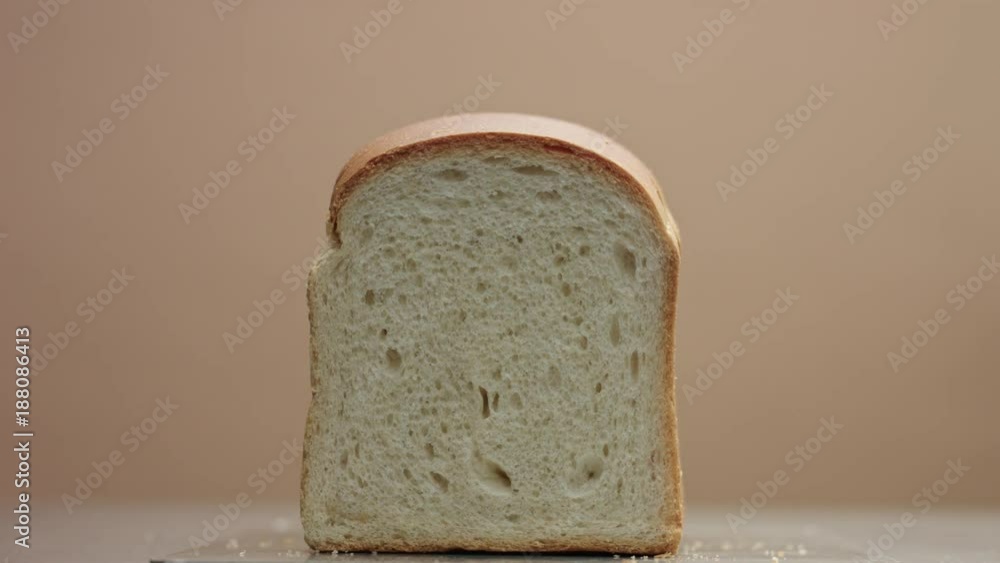 front view of brick of bread. Mans hand take off a front part of bread ...