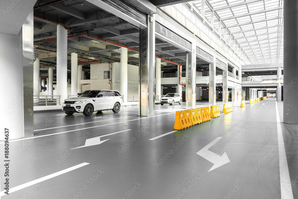 interior of parking garage with car and vacant parking lot in parking ...