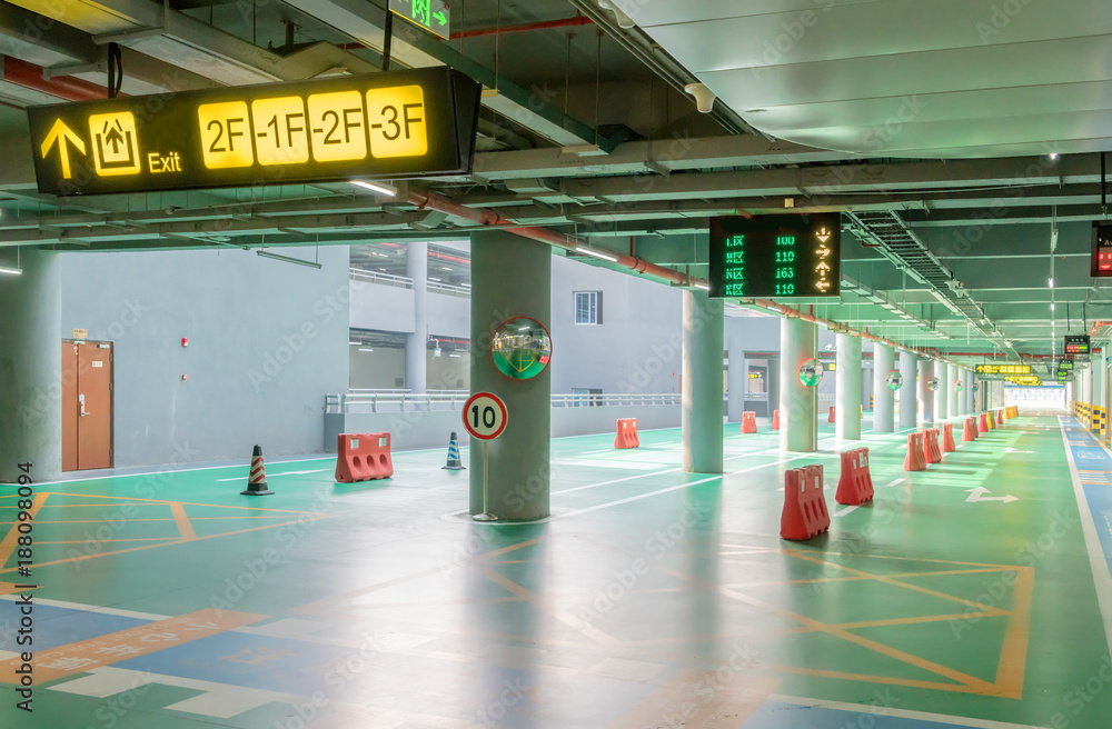 interior of parking garage with car and vacant parking lot in parking ...