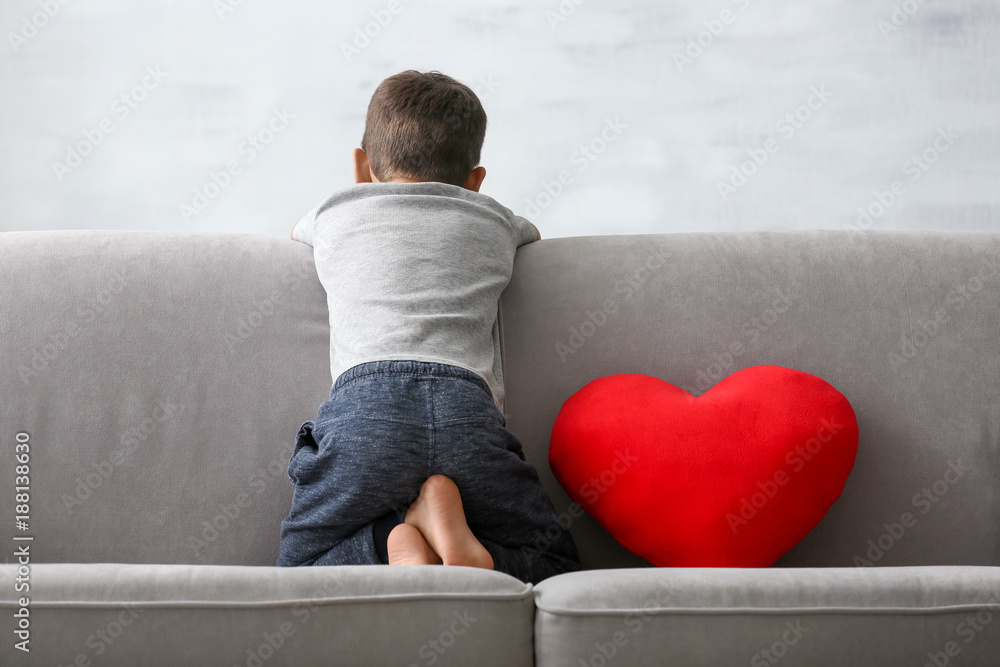 Little boy sitting on sofa at home. Child autism Stock Photo | Adobe Stock