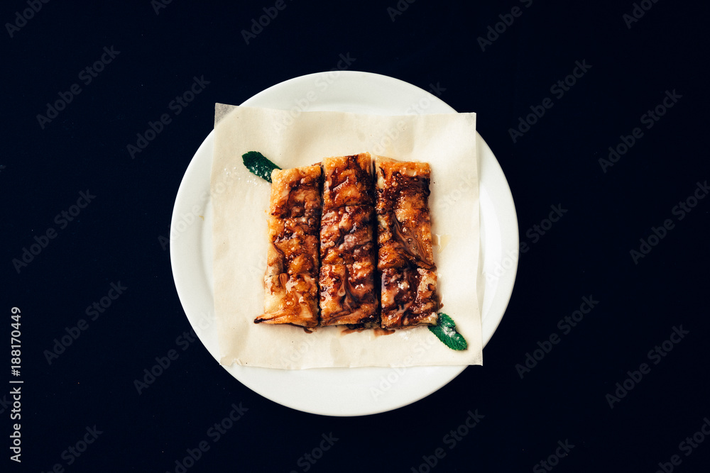three fresh rolled stuffed crepes on plate, filtered imageg Stock Photo ...