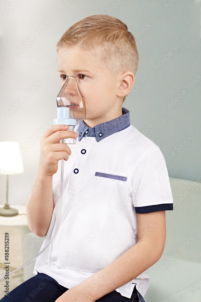 Boy making inhalation with nebulizer at home. child asthma inhaler ...