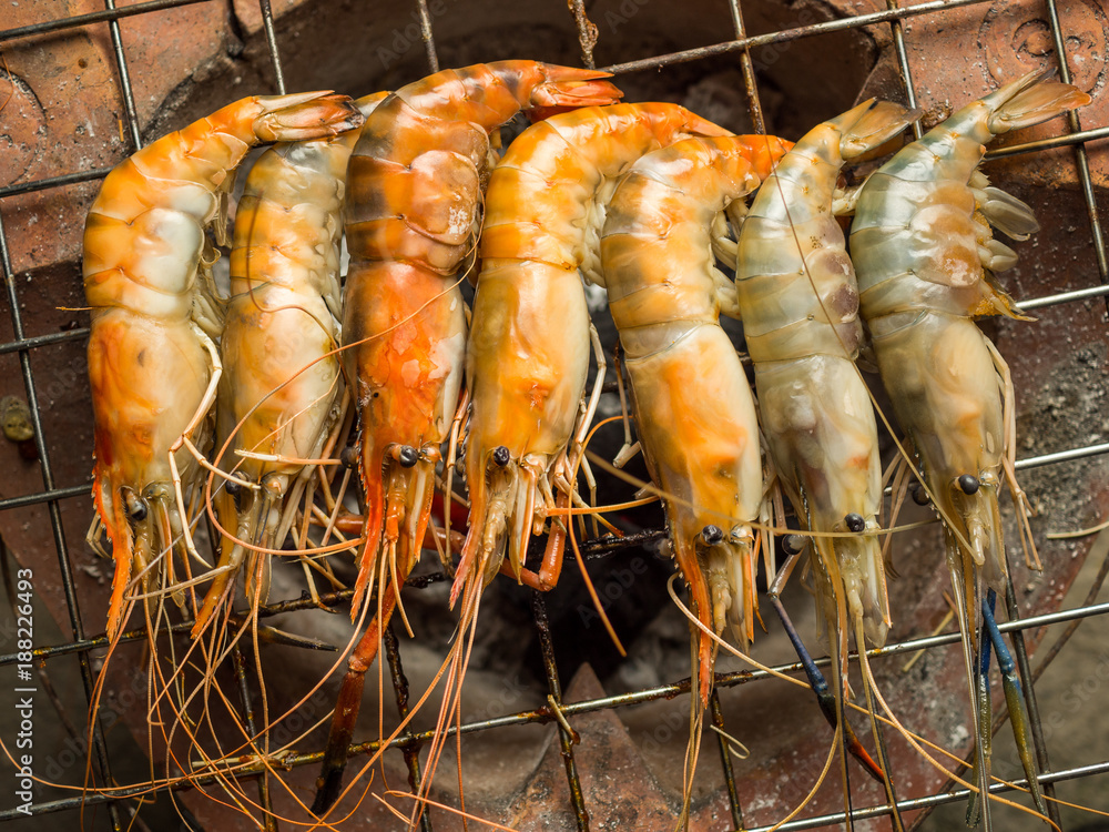Top view of grilled shrimps (Giant Malaysian Prawn) on flaming grill ...