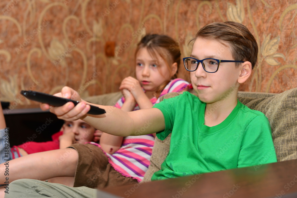 teen siblings brother and sister watching tv close up indoors portrait ...