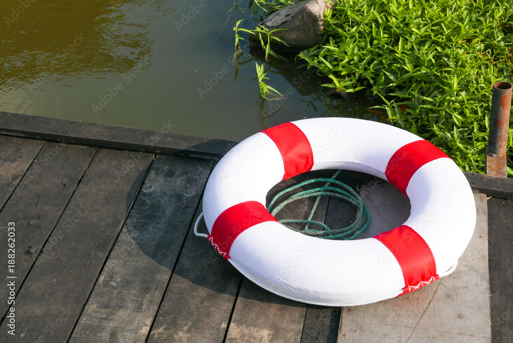 Poster Bright red and white life preserver on a dock – Wall Art | UkPosters