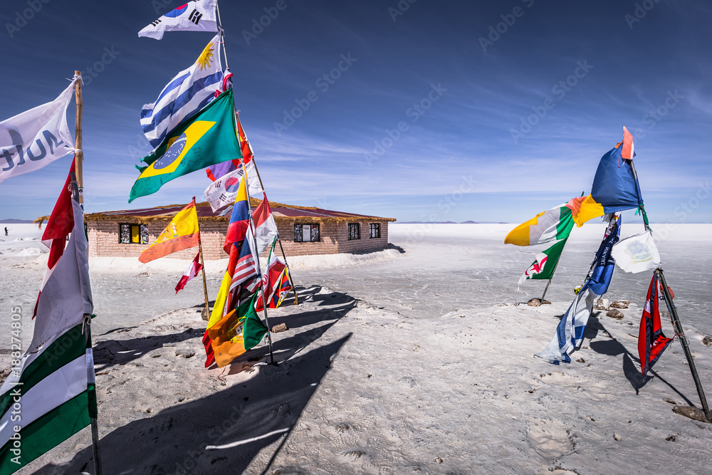 Uyuni Salt Flats - July 20, 2017: Flags landmark at the Uyuni Salt ...