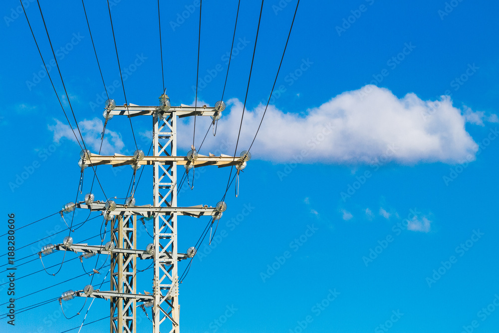 High voltage power lines and electric transmission pylon with blue sky ...