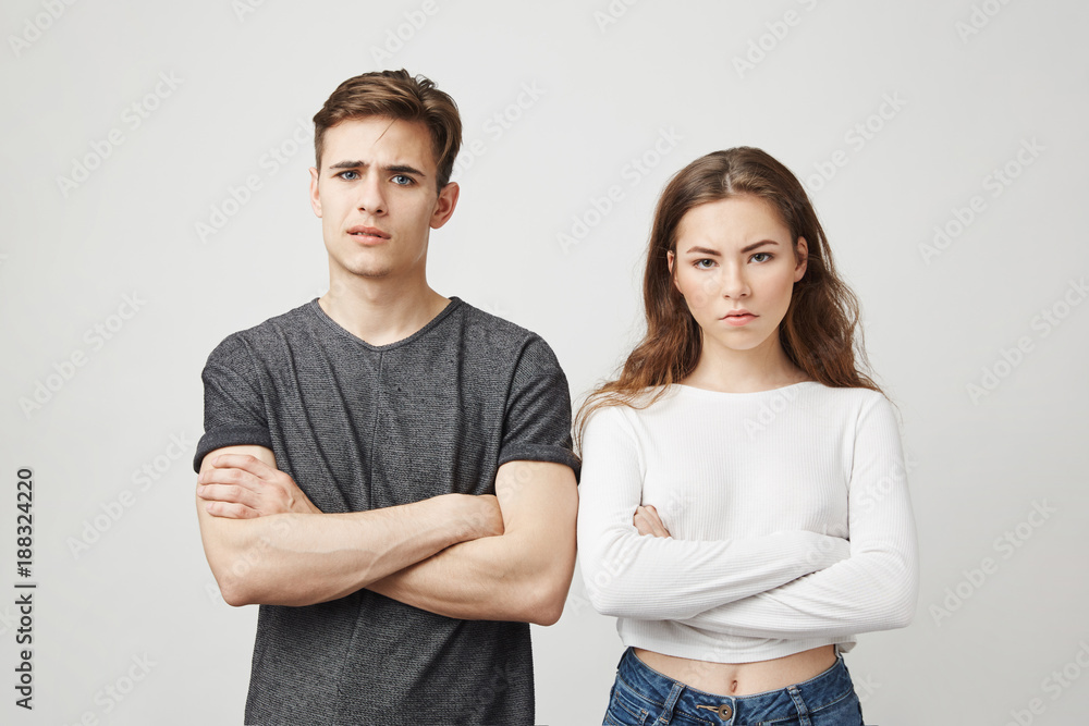 Two people standing in poses looking disappointed. Friends angry at ...