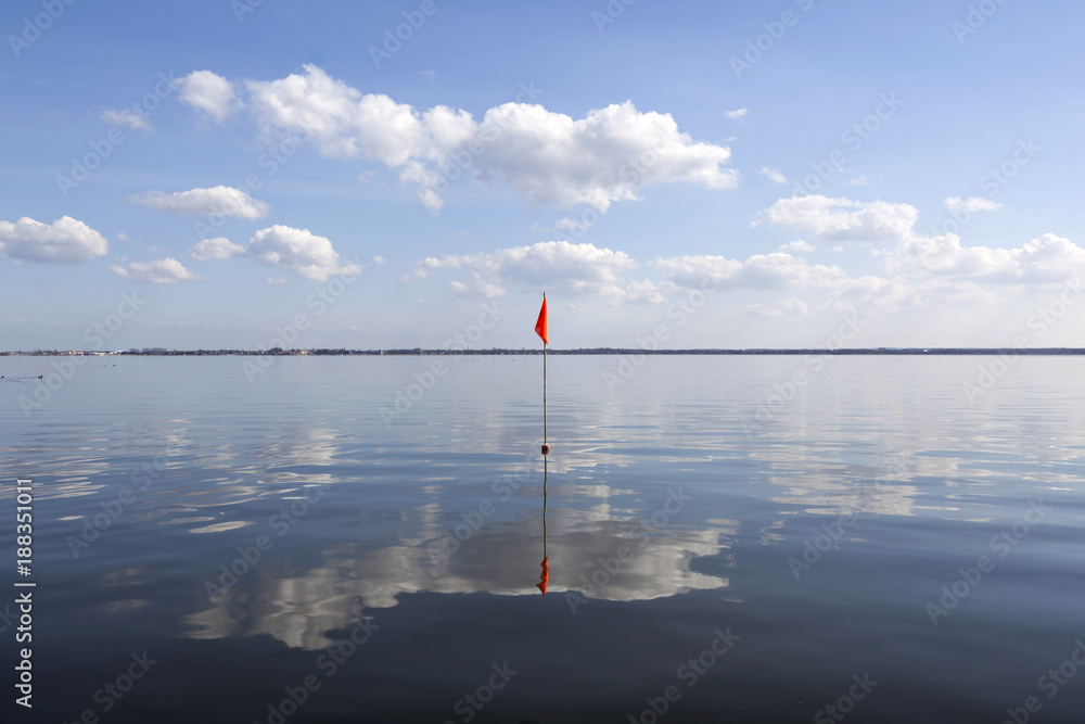 orange red flag floating in water as marker for shallow water Stock ...