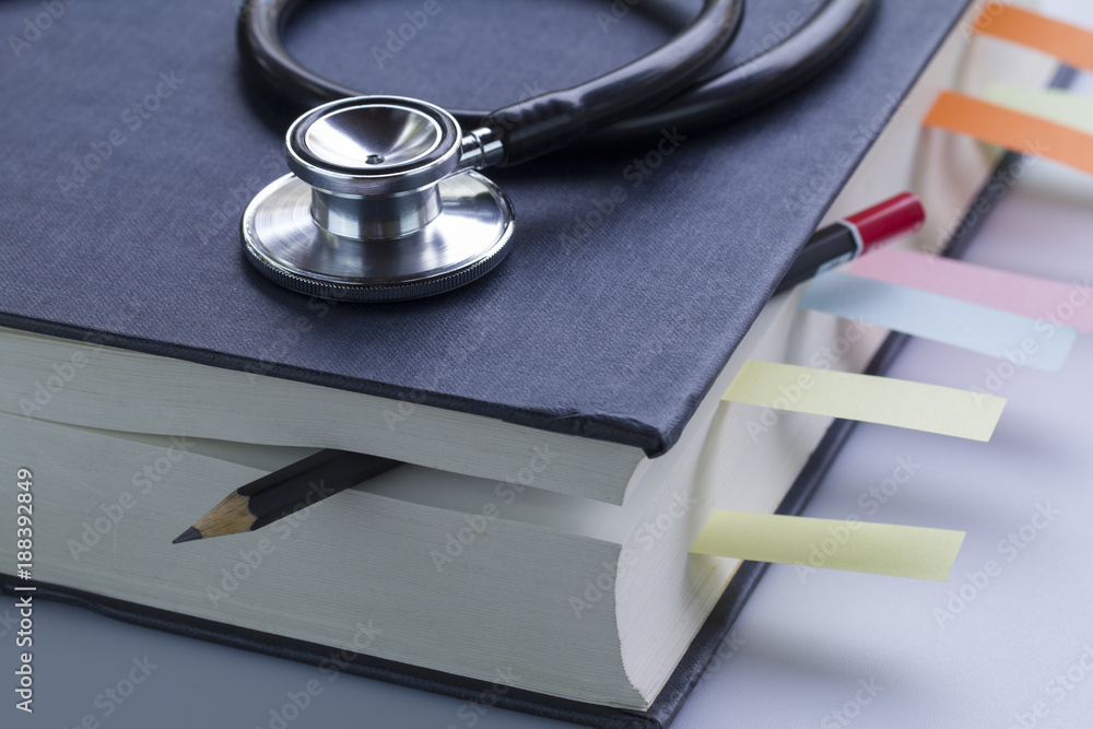 Medical student textbook with pencil and multicolor bookmarks and ...
