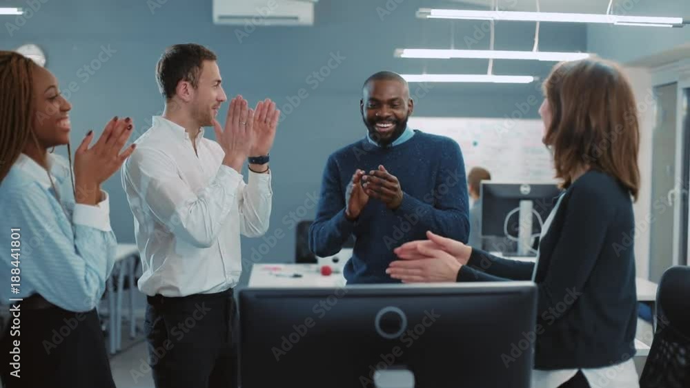 Four colleagues from prestigious law firm celebrating victory. Young ...