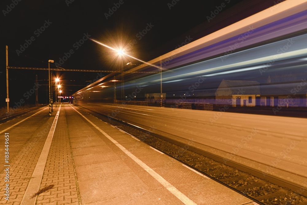 Light trail of the express train in the railway station at the night ...