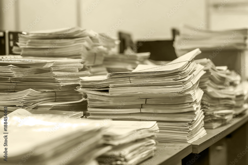 bundles bales of paper documents. stacks packs pile on the desk in the ...