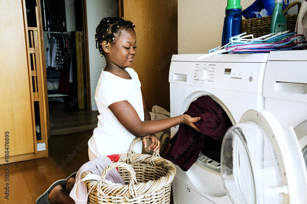 Young teen girl washing clothes using washing machine Stock Photo ...