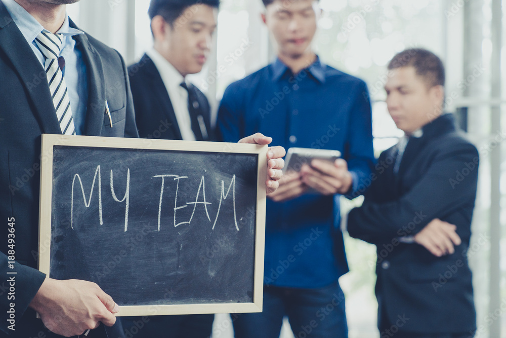 "My Team" wording on chalk blackboard in a hand of businessman in ...