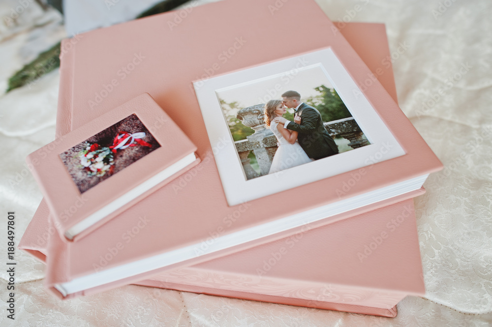 Gentle pink wedding photobook or photo album, box, and cd case laying ...