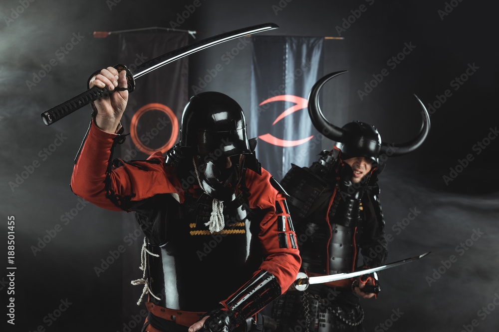 Armored samurai fighting with katana swords in front of clan symbols on ...