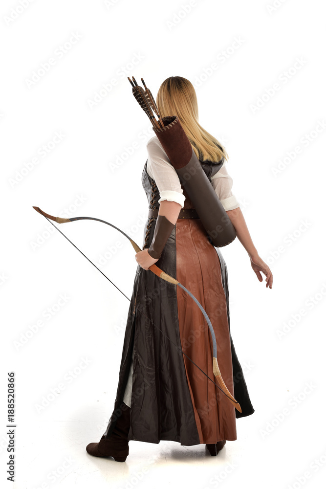 full length portrait of girl wearing brown fantasy costume, holding a ...