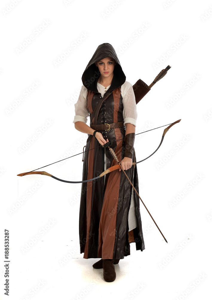 full length portrait of girl wearing brown fantasy costume, holding a ...