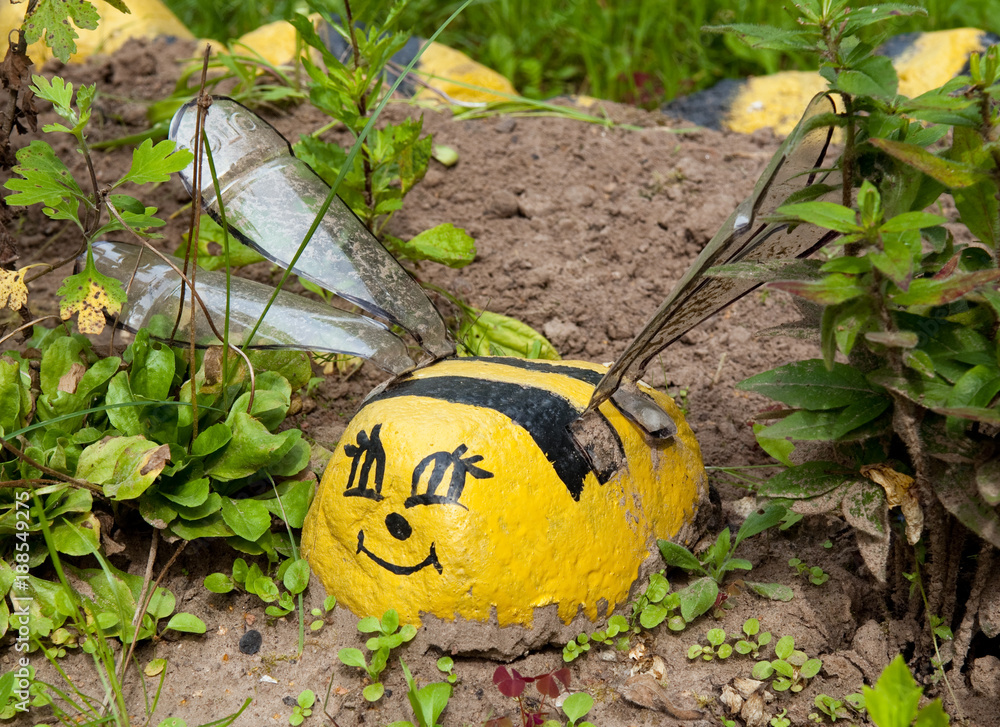 Bee from a small stone with wings of a plastic bottle Stock Photo ...