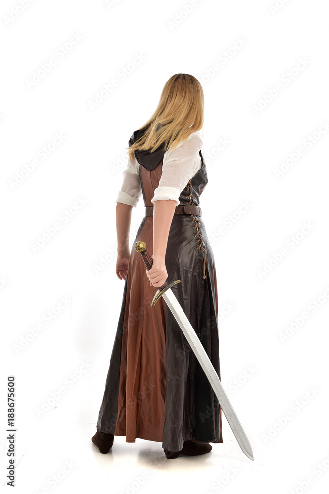 full length portrait of girl wearing brown fantasy costume, holding a ...