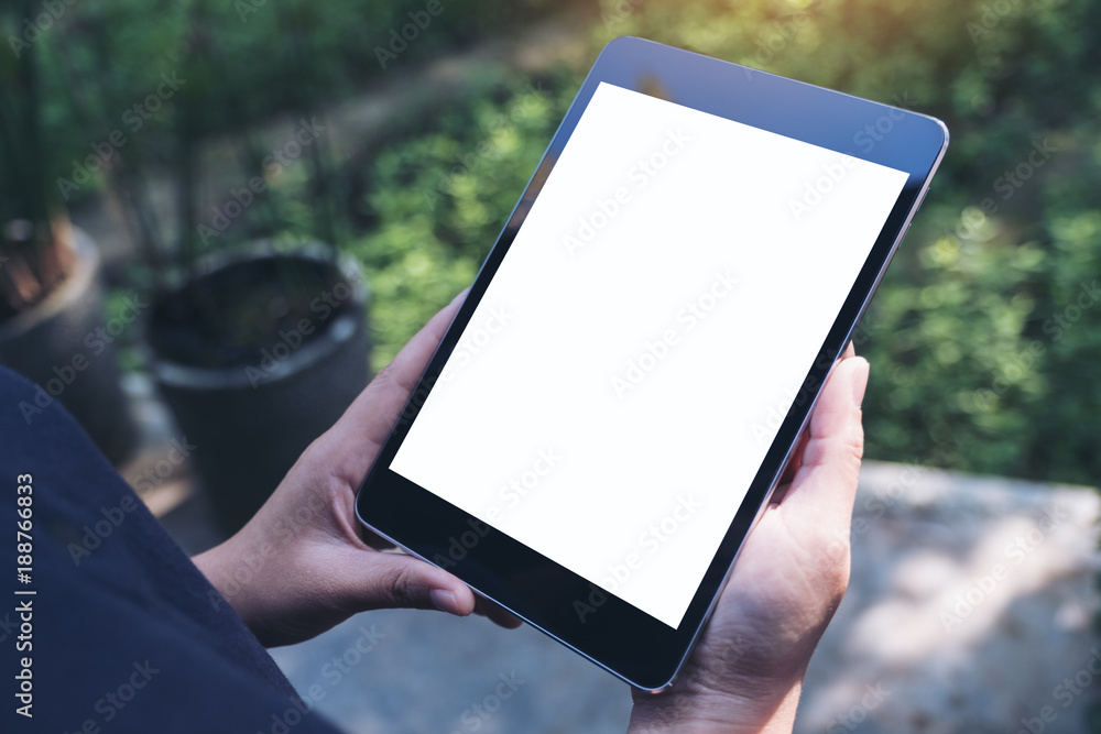 Mockup image of woman's hands holding black tablet pc with blank white ...