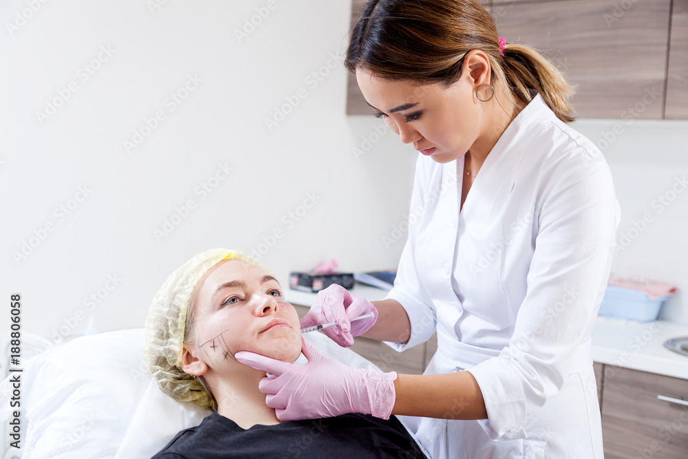 Close-up Young woman azitka doctor cosmetician in white lab coat and ...