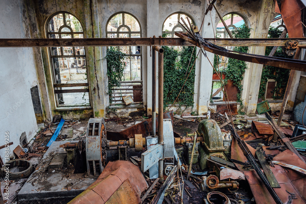 Ruined abandoned electrical substation. Rusty generator at machinery ...