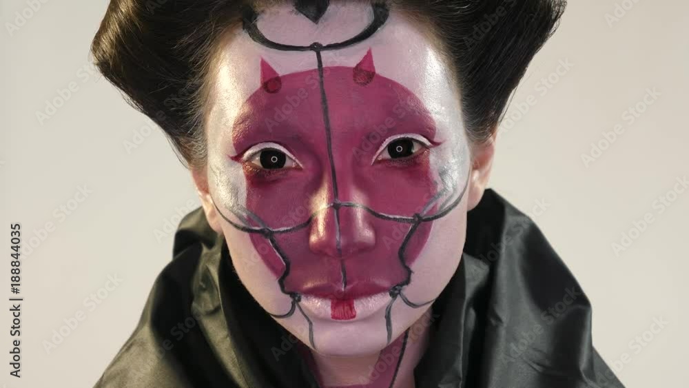 a girl in the shape of a geisha killer from the movie looks at a bright ...