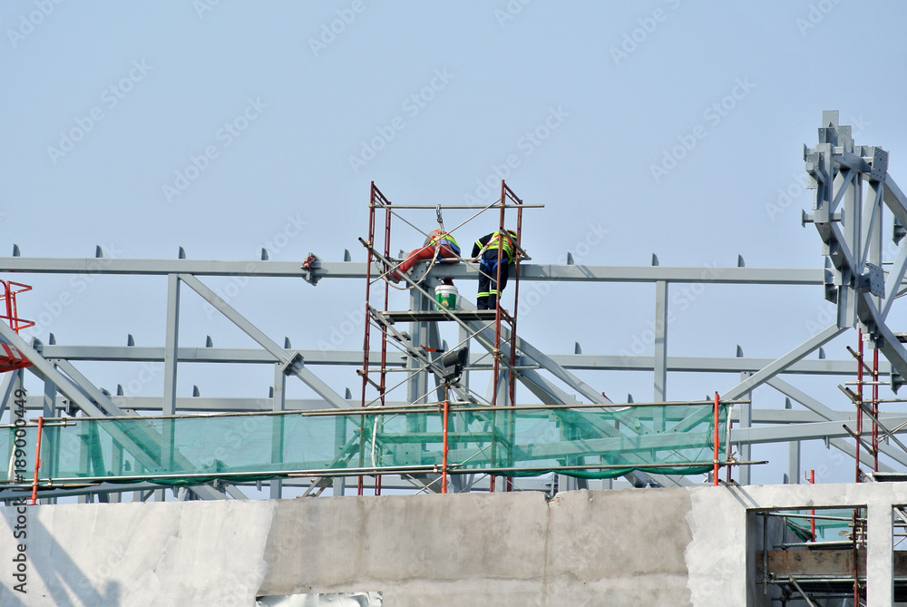 Construction workers working at height without wearing proper safety ...