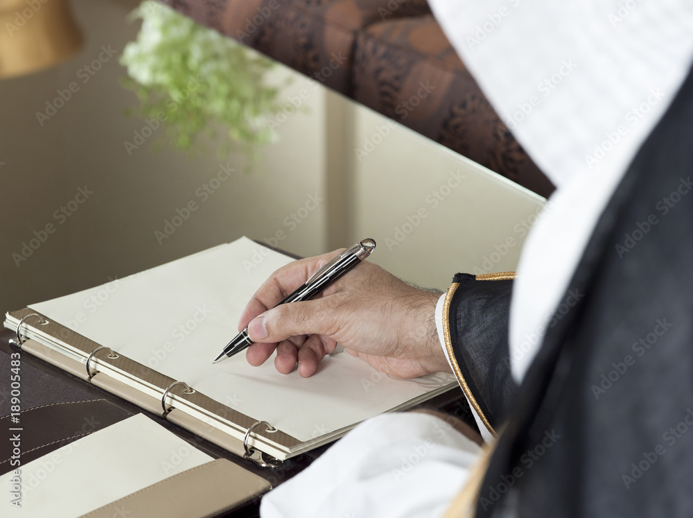 Saudi Arabian Man Hand Writing on A Notebook Stock Photo | Adobe Stock