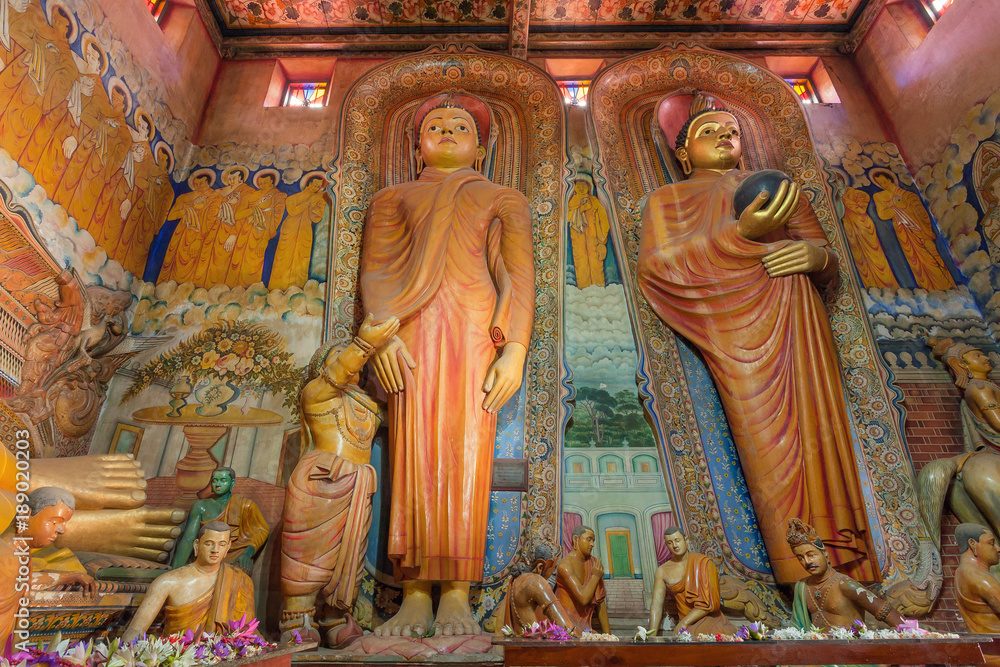 Buddha statues in full growth and his followers in the temple with ...
