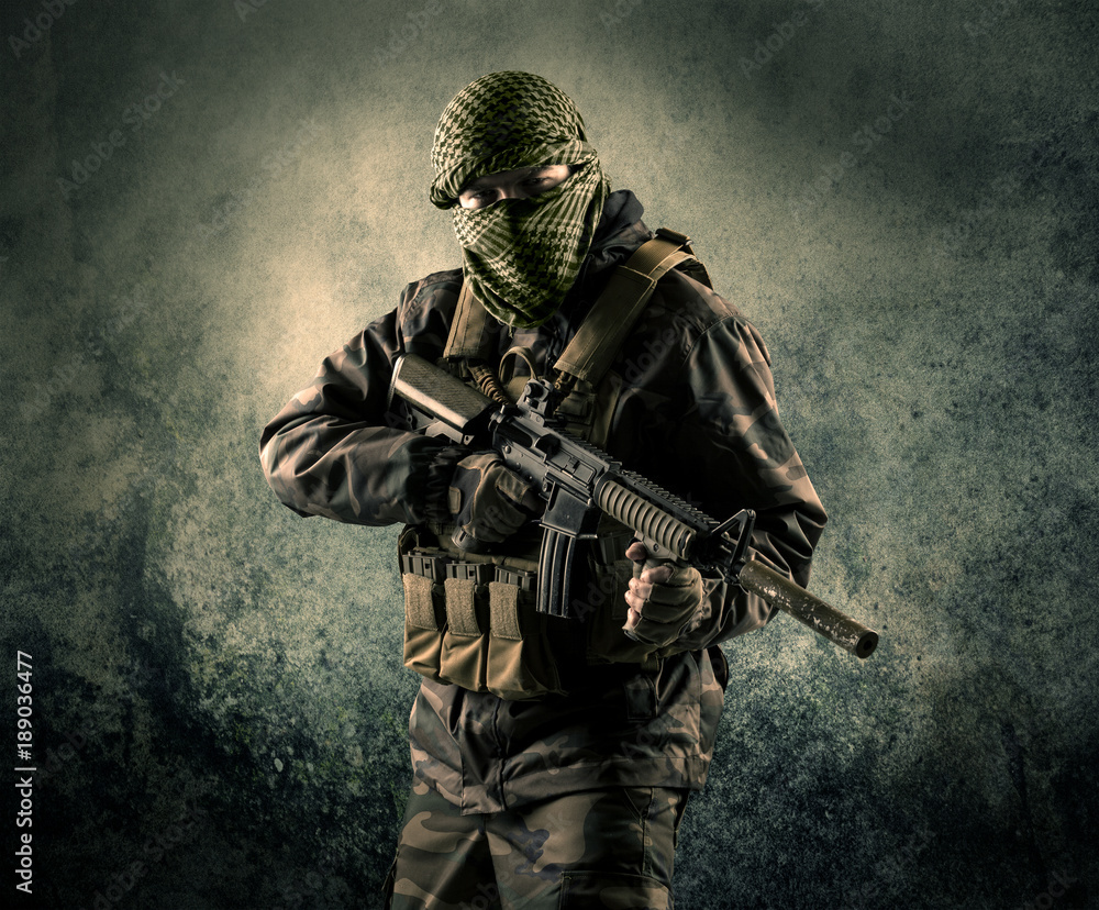 Portrait of a heavily armed masked soldier with grungy background Stock ...