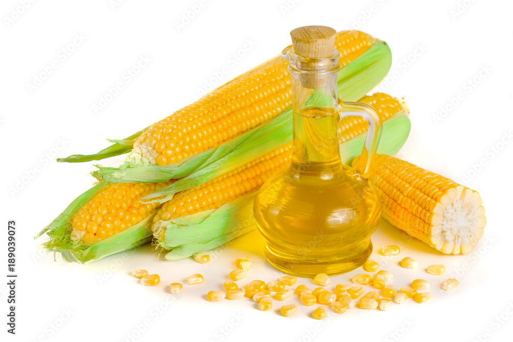 Corn oil in decanter, fresh corn cobs and grains isolated on white ...