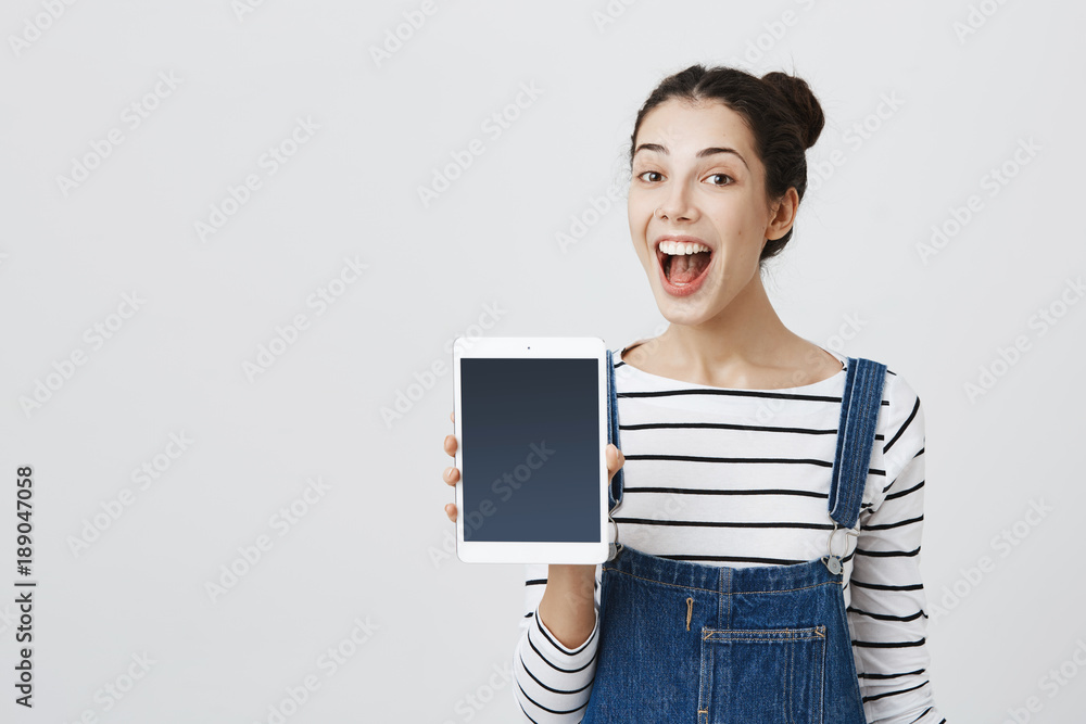 Surprised beautiful brunette girl with two hair buns standing against ...