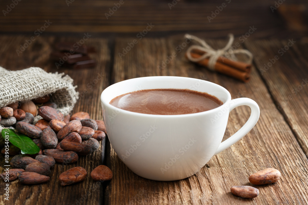 Hot chocolate in the cup on the wooden table. Stock Photo | Adobe Stock