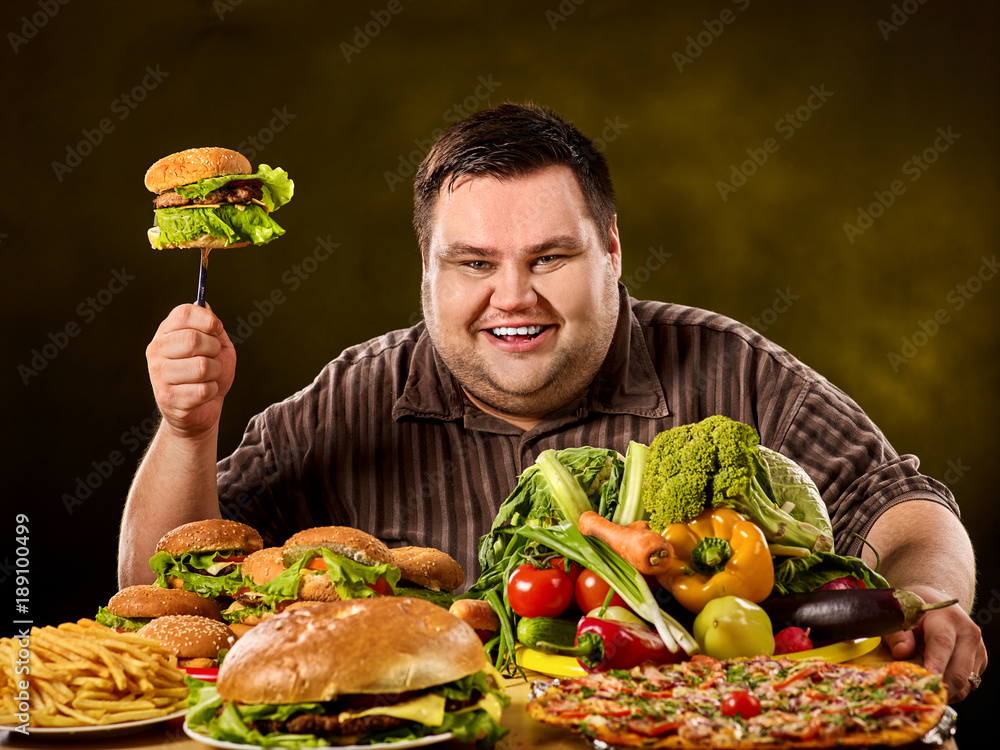 Fat man who makes choice between healthy and unhealthy food. Overweight ...