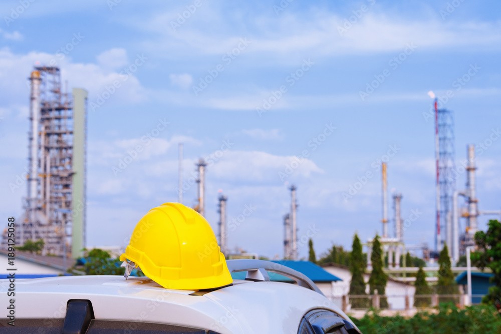 Helmet on the roof of car,oil refinery plant,oil tank and oil storage ...