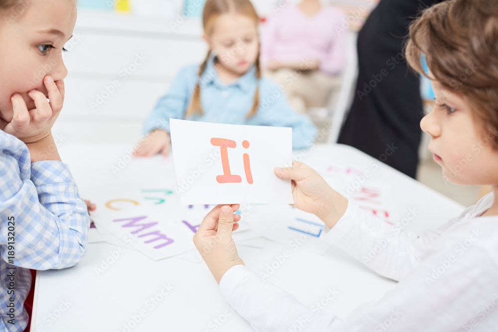 Clever little kids learning english alphabet at lesson, boy showing ...