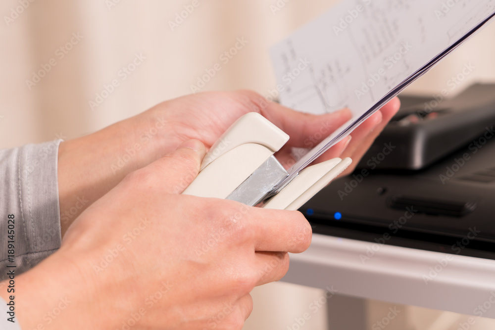 focus on the women hand stapling the hand writing paper, working and ...