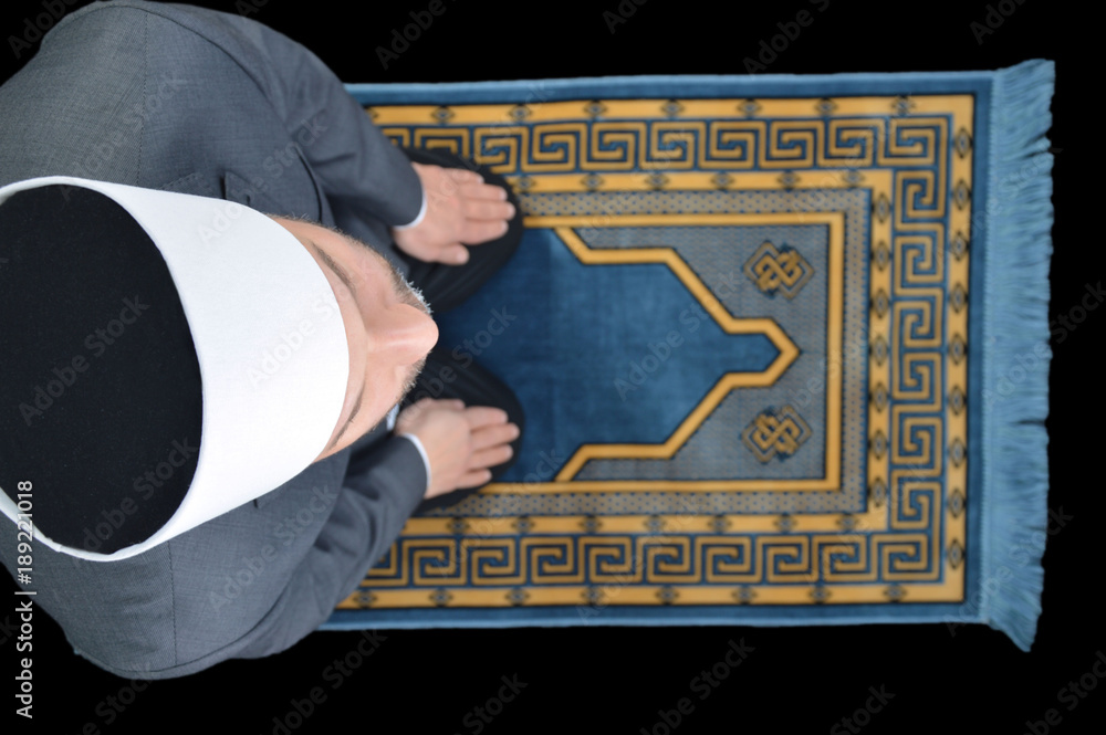 Poster Overhead view of man praying on prayer mat – Wall Art | UkPosters