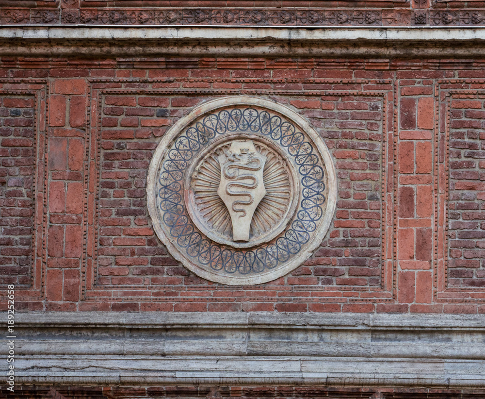 the snake, symbols of the ancient Lords of Milan, on the red brick wall ...