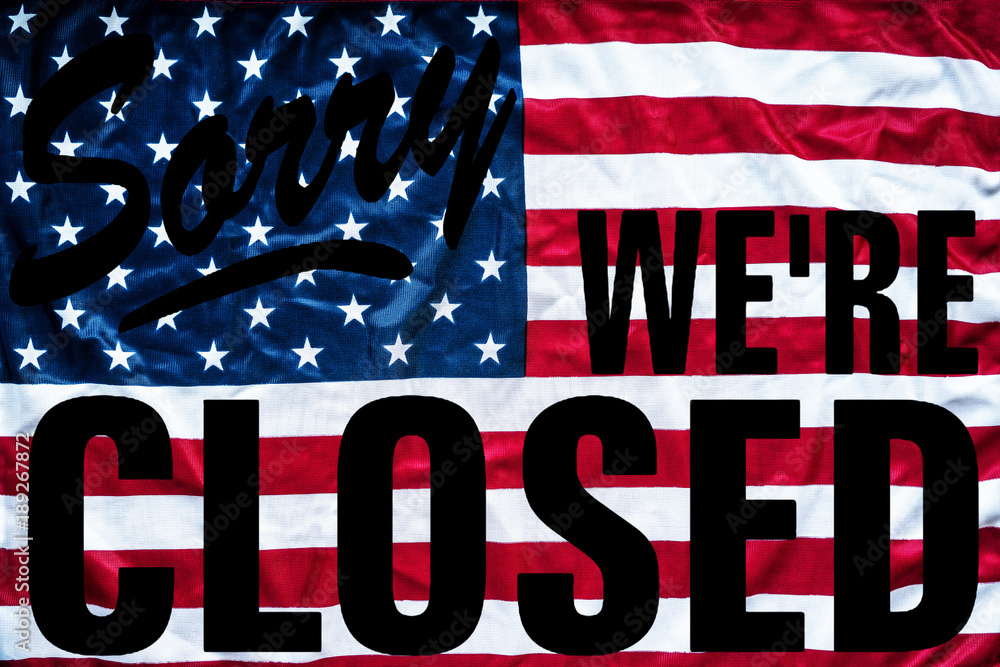 government shutdown represented by a sorry we're closed sign outline ...