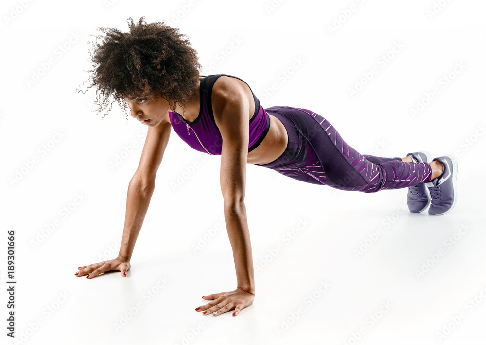 Strong girl doing push up. Photo of sporty african girl doing ...