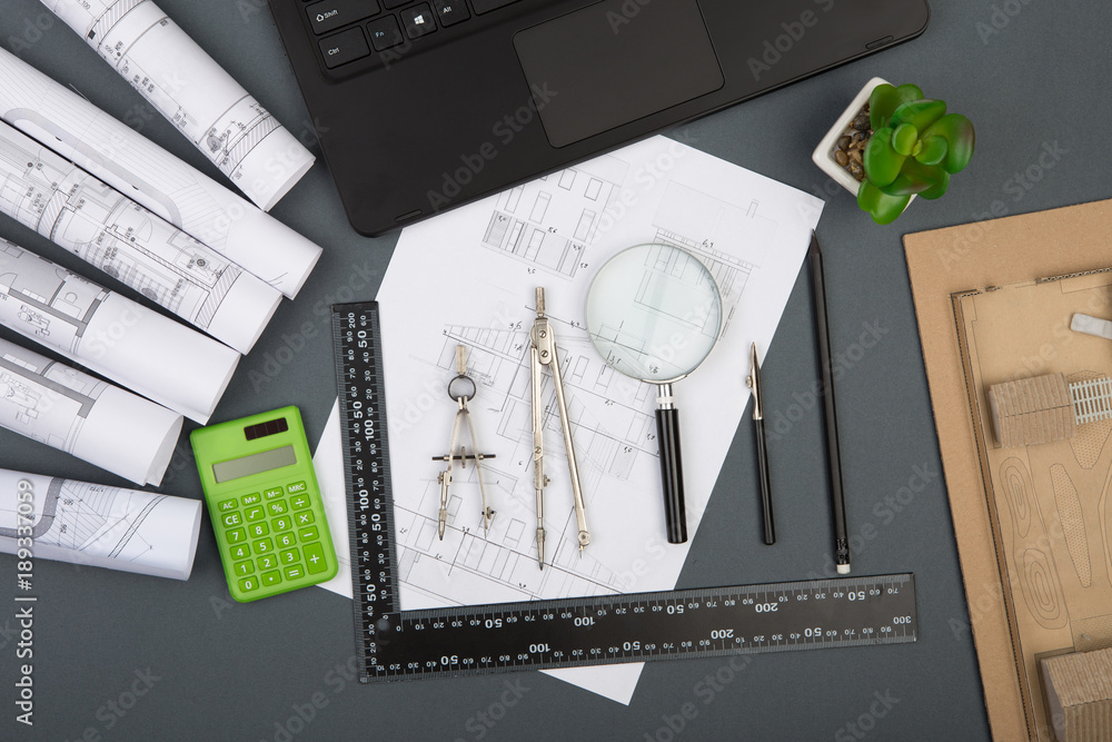 Workplace of architect - construction drawings, scale model and tools ...