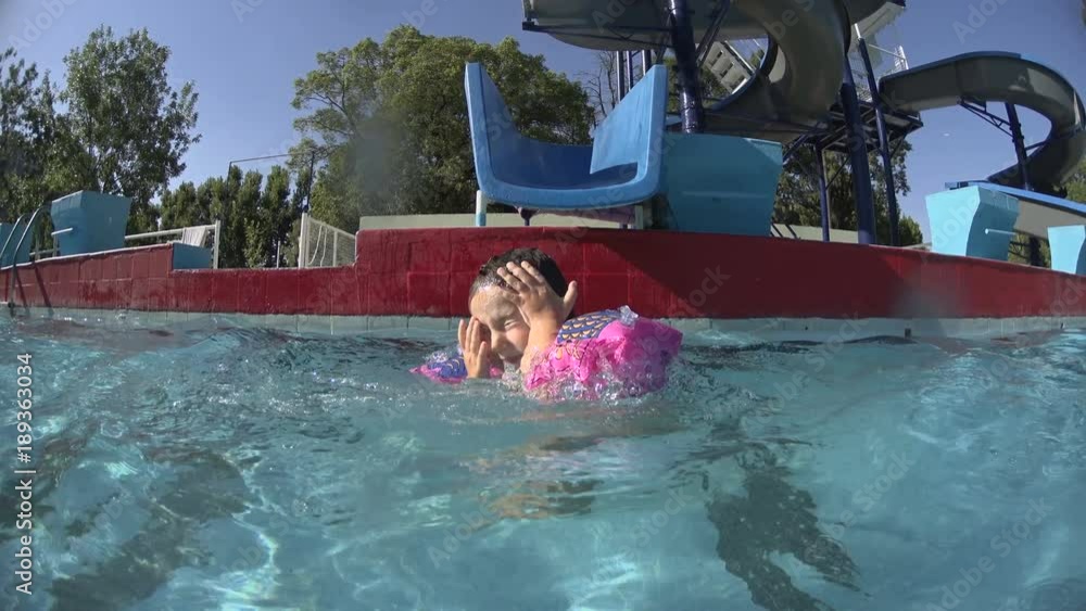 Little Girl Jumps from water slide Learning Swimming in pool. Perfect ...
