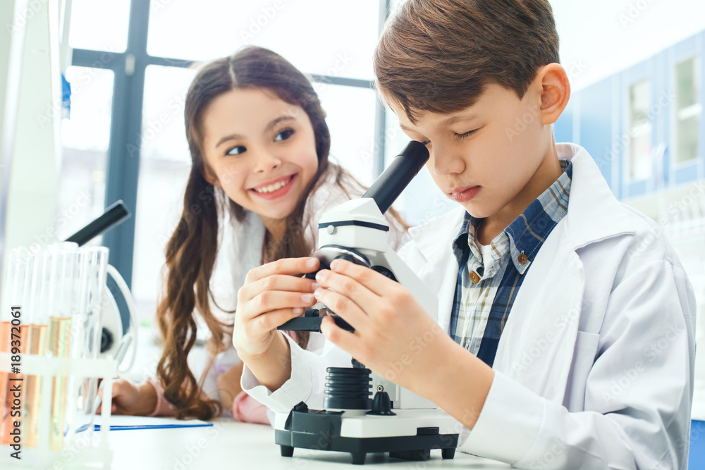 Little kids learning chemistry in school laboratory microscope ...