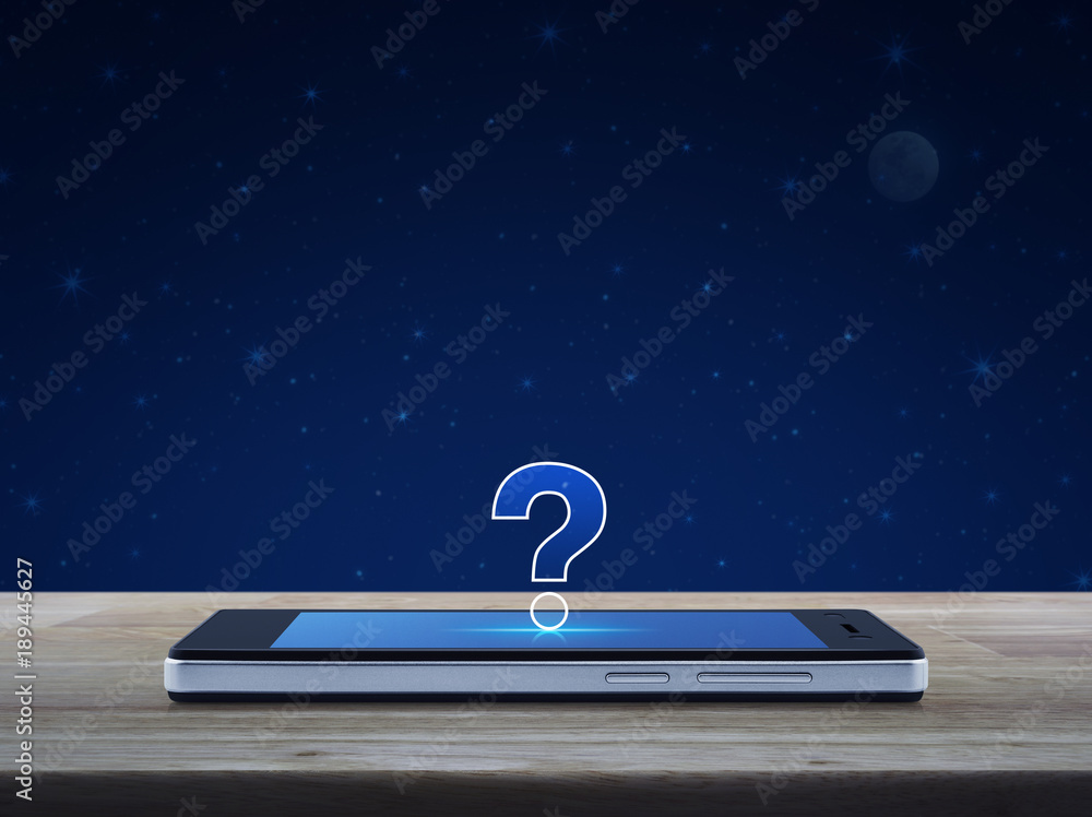 Question mark icon on modern smart phone screen on wooden table over ...